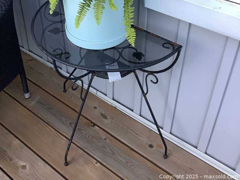 Black metal demilune glass-top table | Maxsold