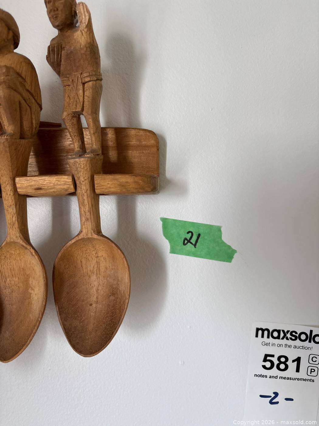 Carved spoon rack with figural spoons and silhouette plaque | Maxsold