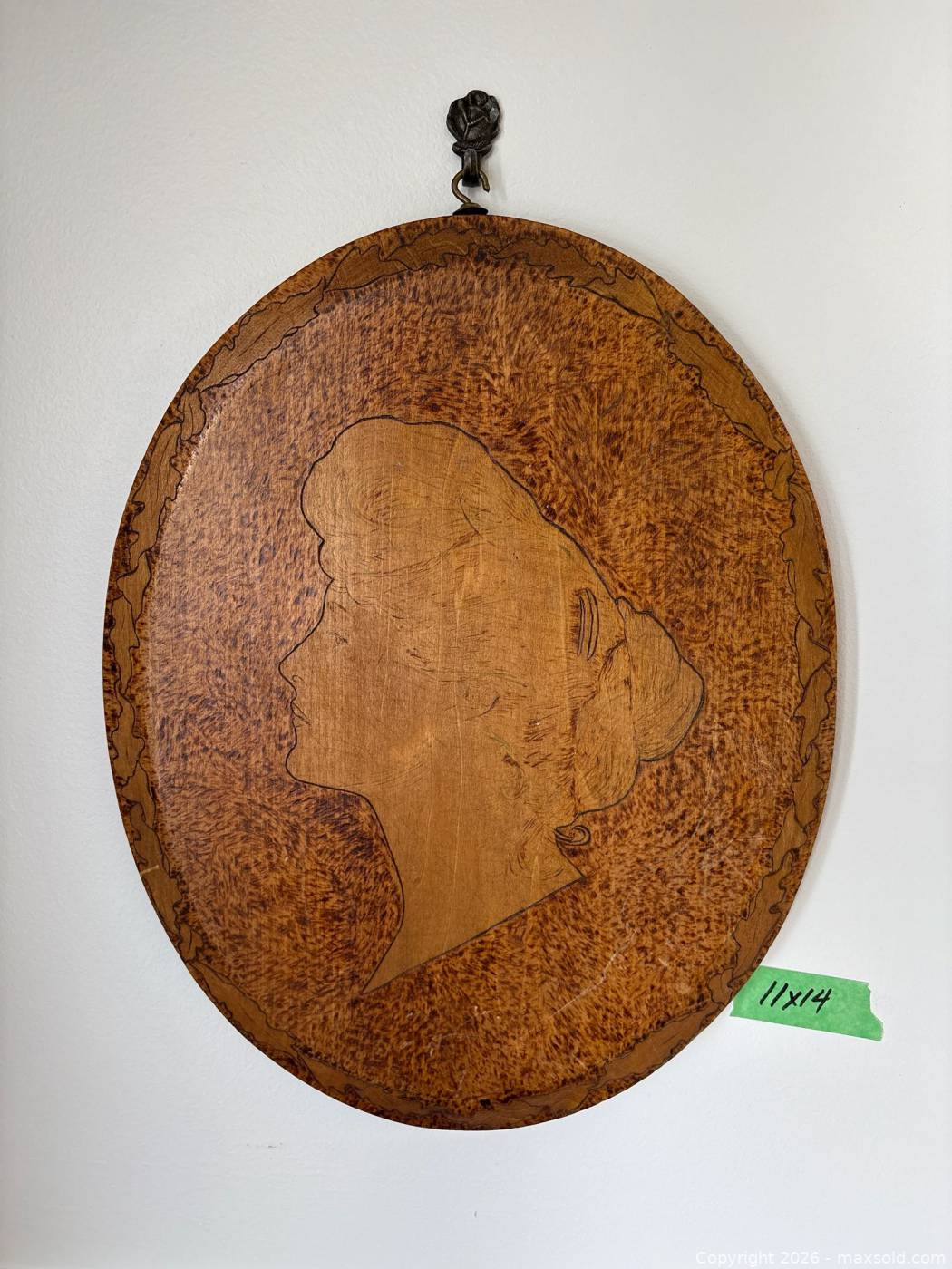 Carved spoon rack with figural spoons and silhouette plaque | Maxsold