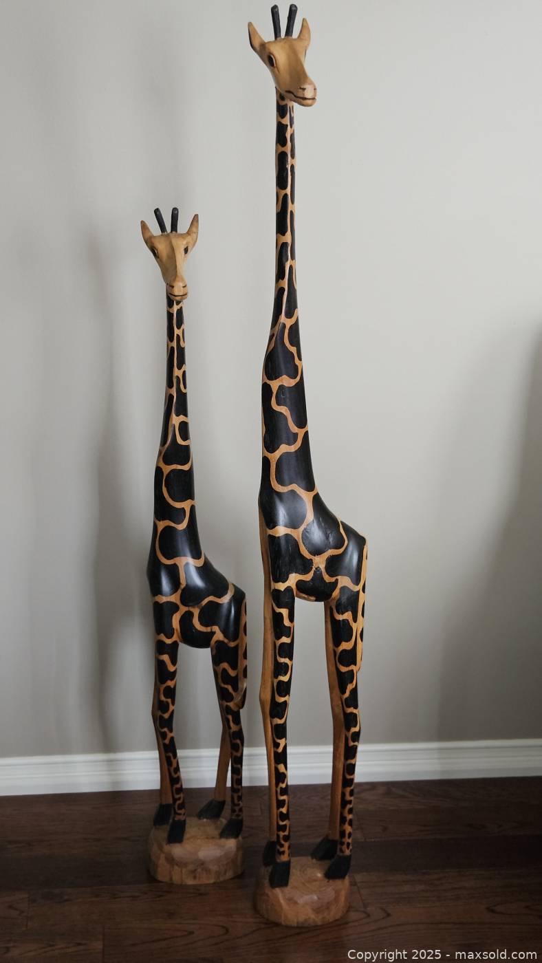 Pair of carved wood giraffe sculptures | Maxsold