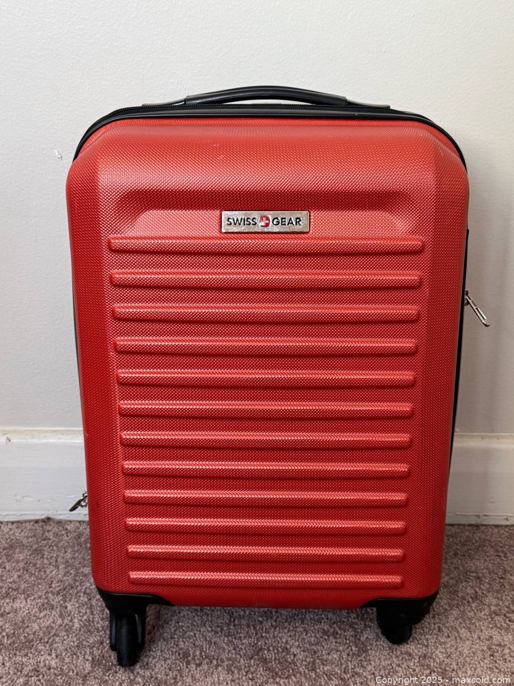 Swiss Gear red hard shell carry-on suitcase | Maxsold