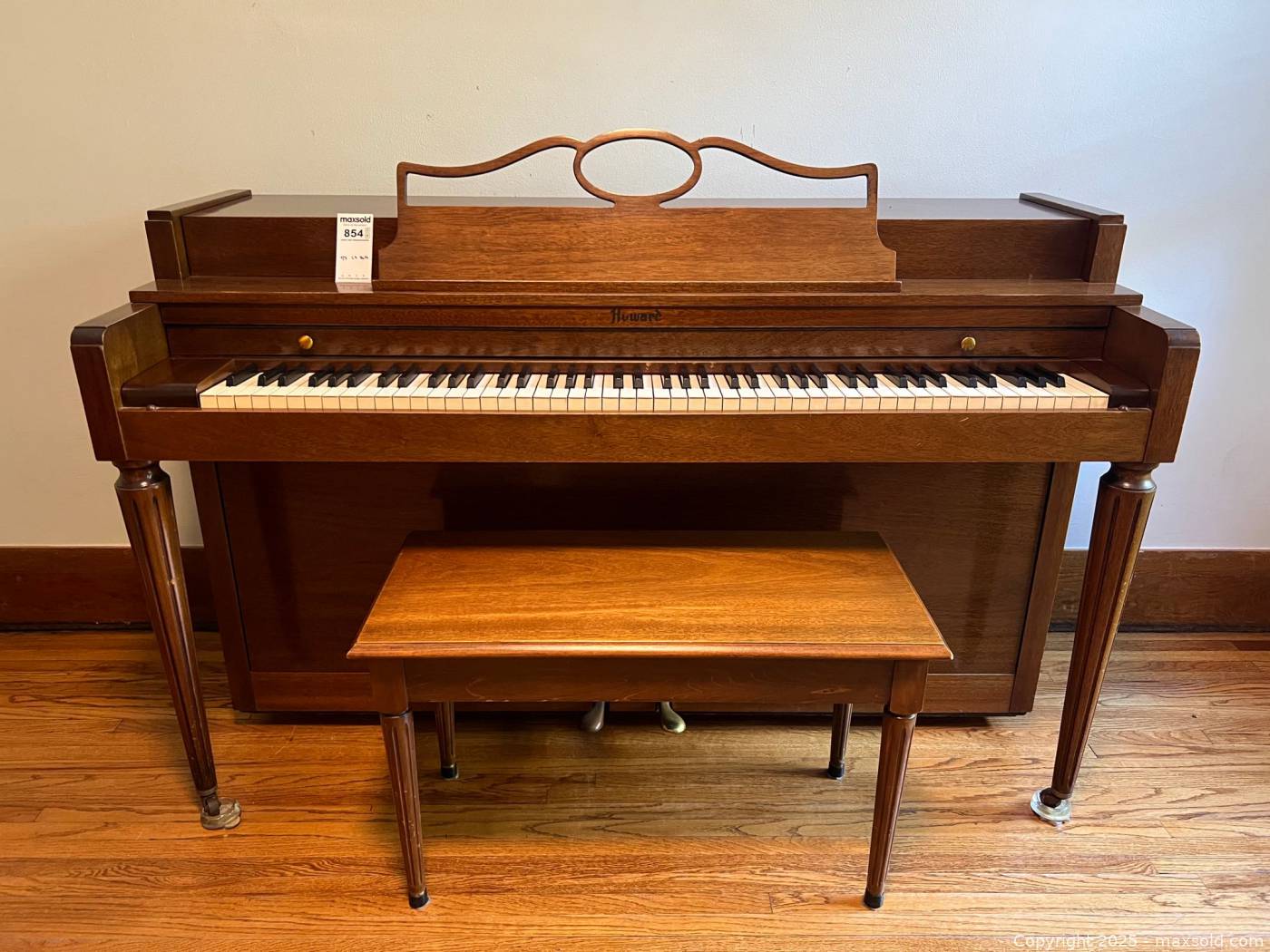 Howard walnut upright piano with bench | Maxsold