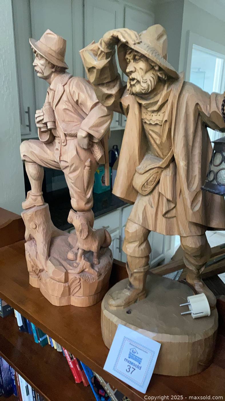 Wood carved statues of two men | Maxsold