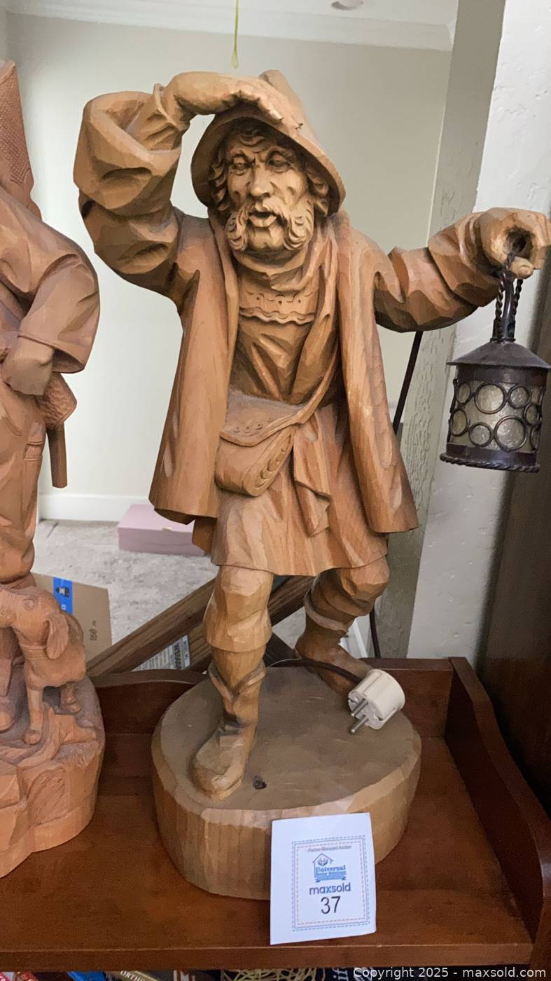 Wood carved statues of two men | Maxsold