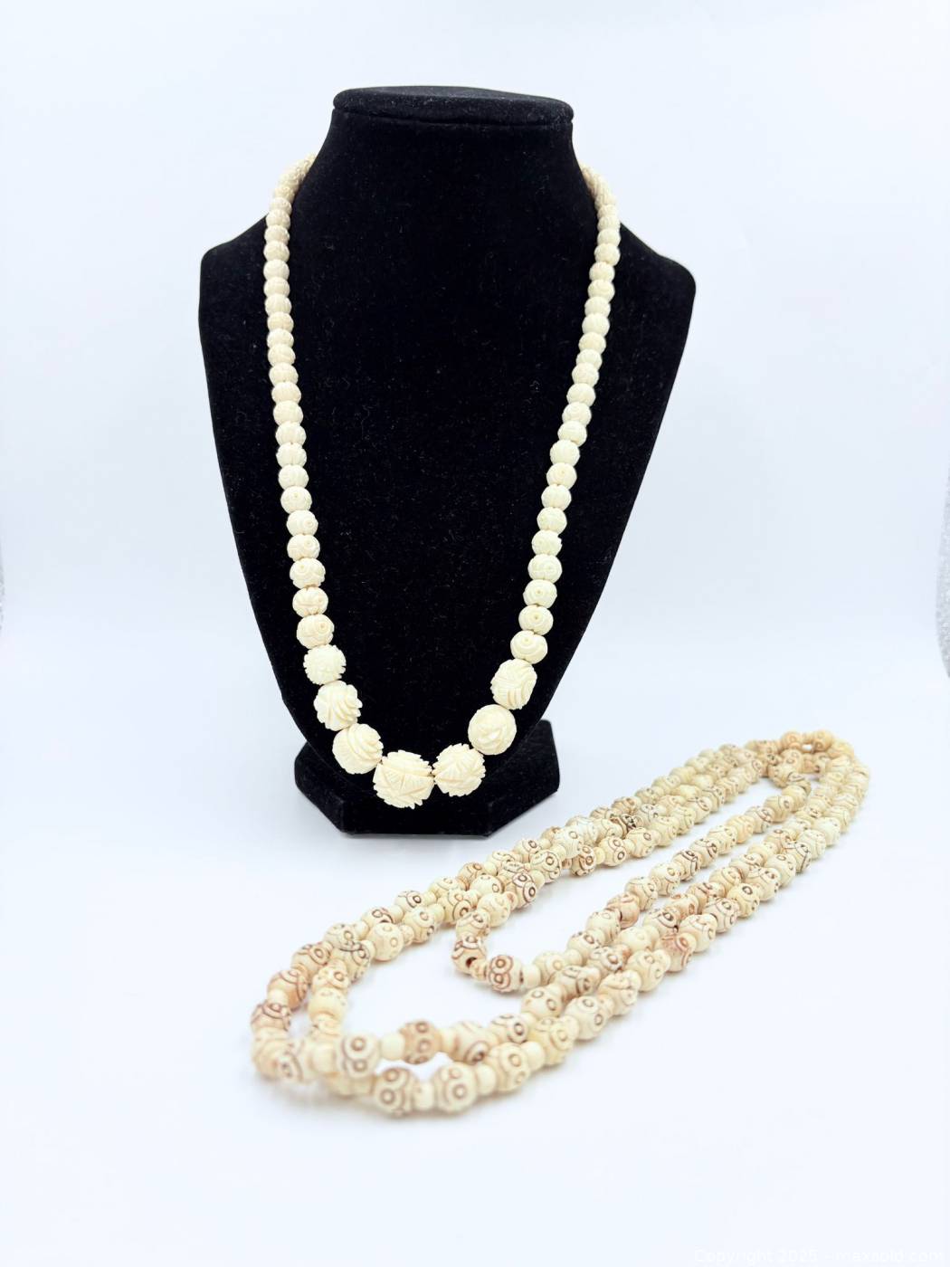 Carved bone bead necklace pair | Maxsold