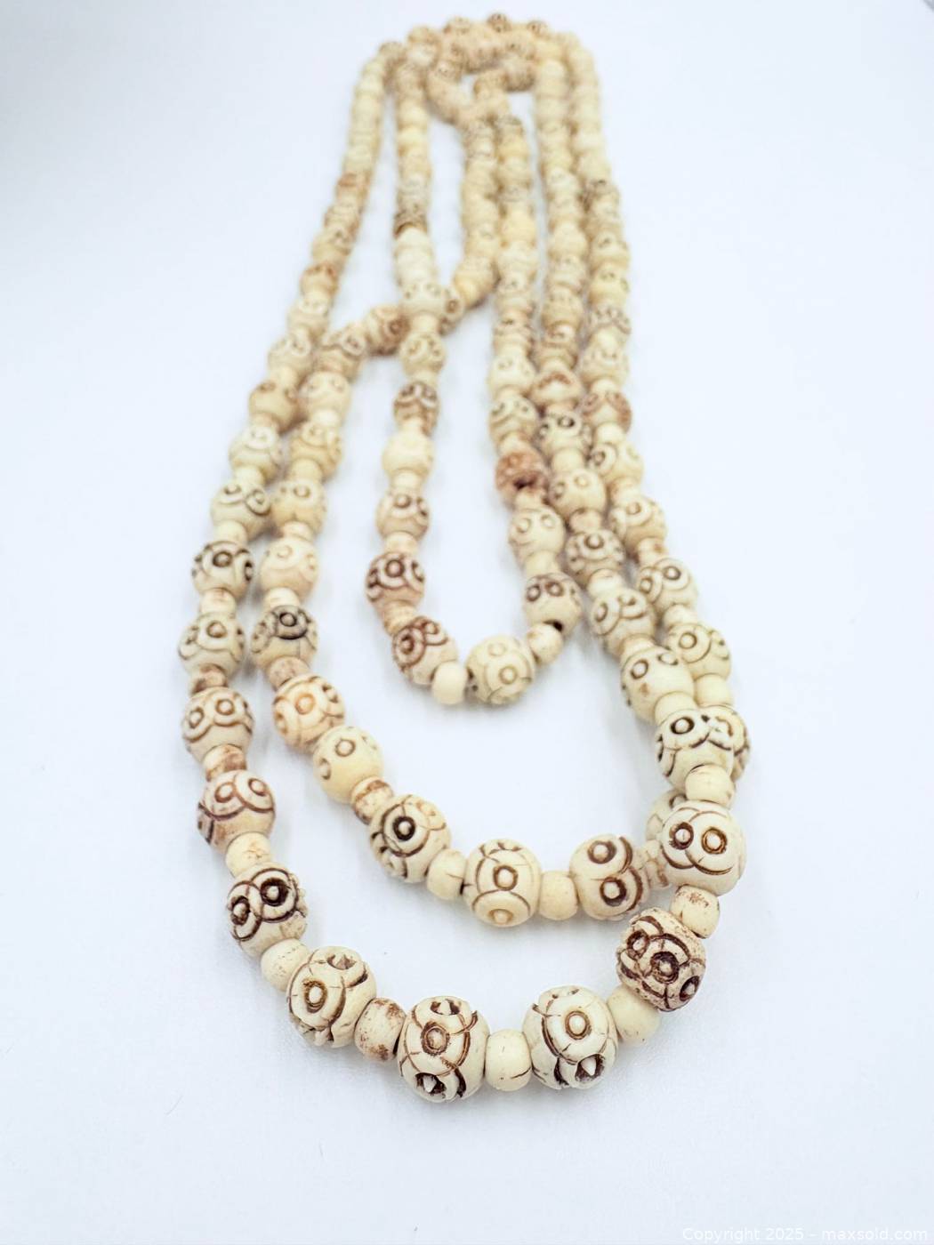 Carved bone bead necklace pair | Maxsold