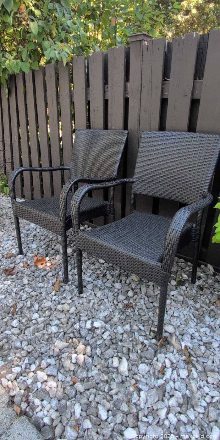 Pair of plastic rattan outdoor arm chairs | Maxsold