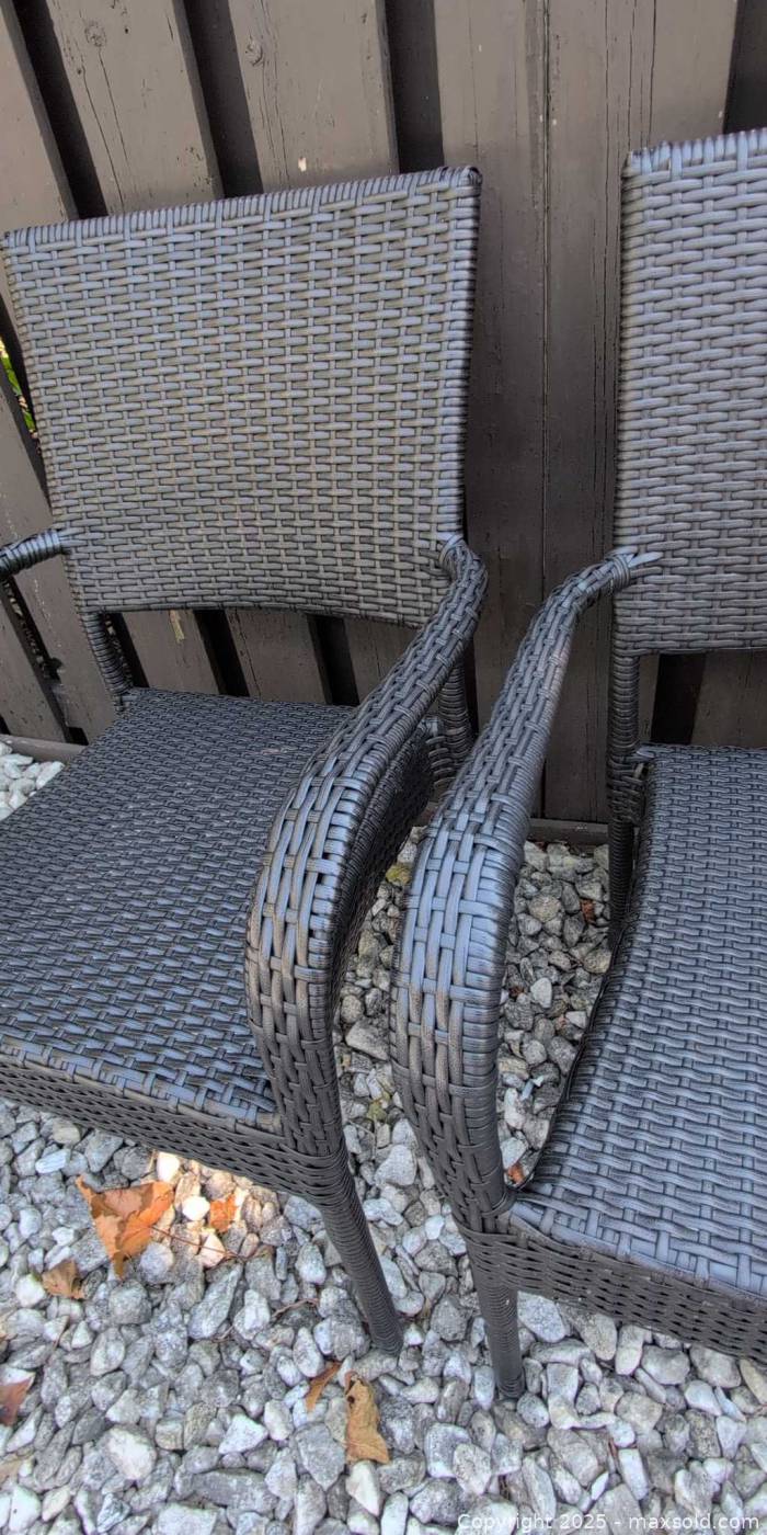 Pair of plastic rattan outdoor arm chairs | Maxsold