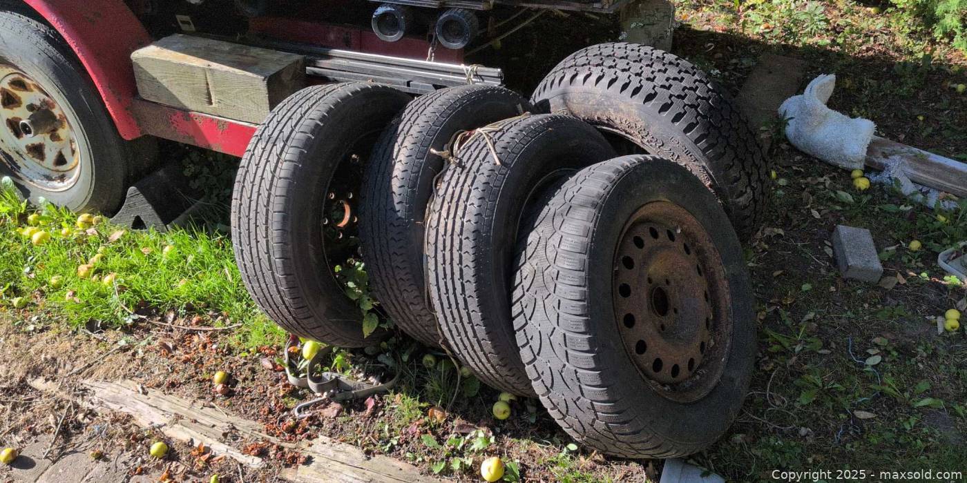 Wooden runabout hull on dual-axle trailer with loose tires | Maxsold