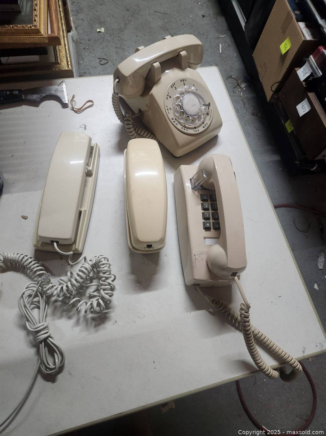 Four cream-beige landline telephones | Maxsold
