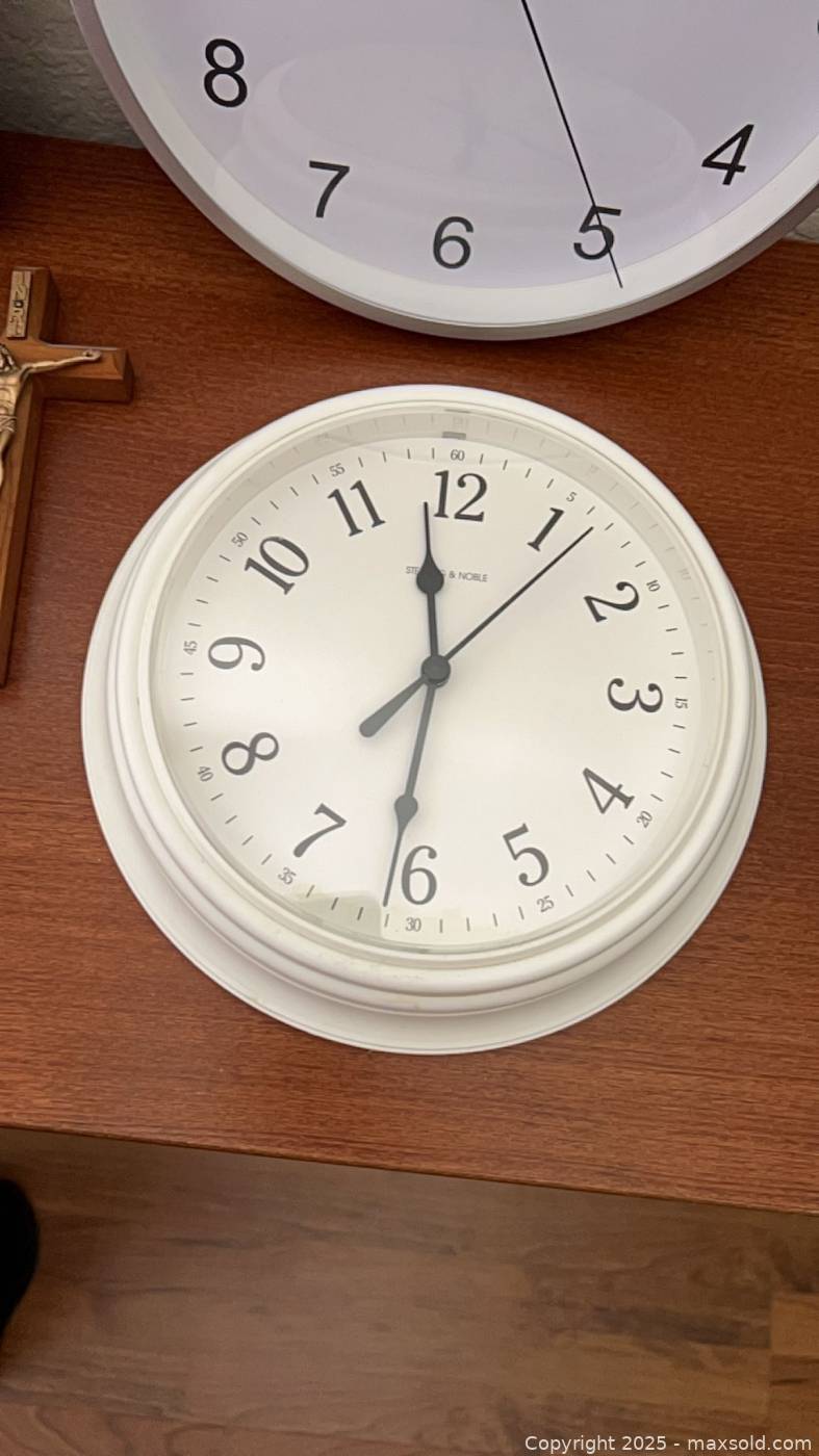 Two wall clocks and crucifix | Maxsold