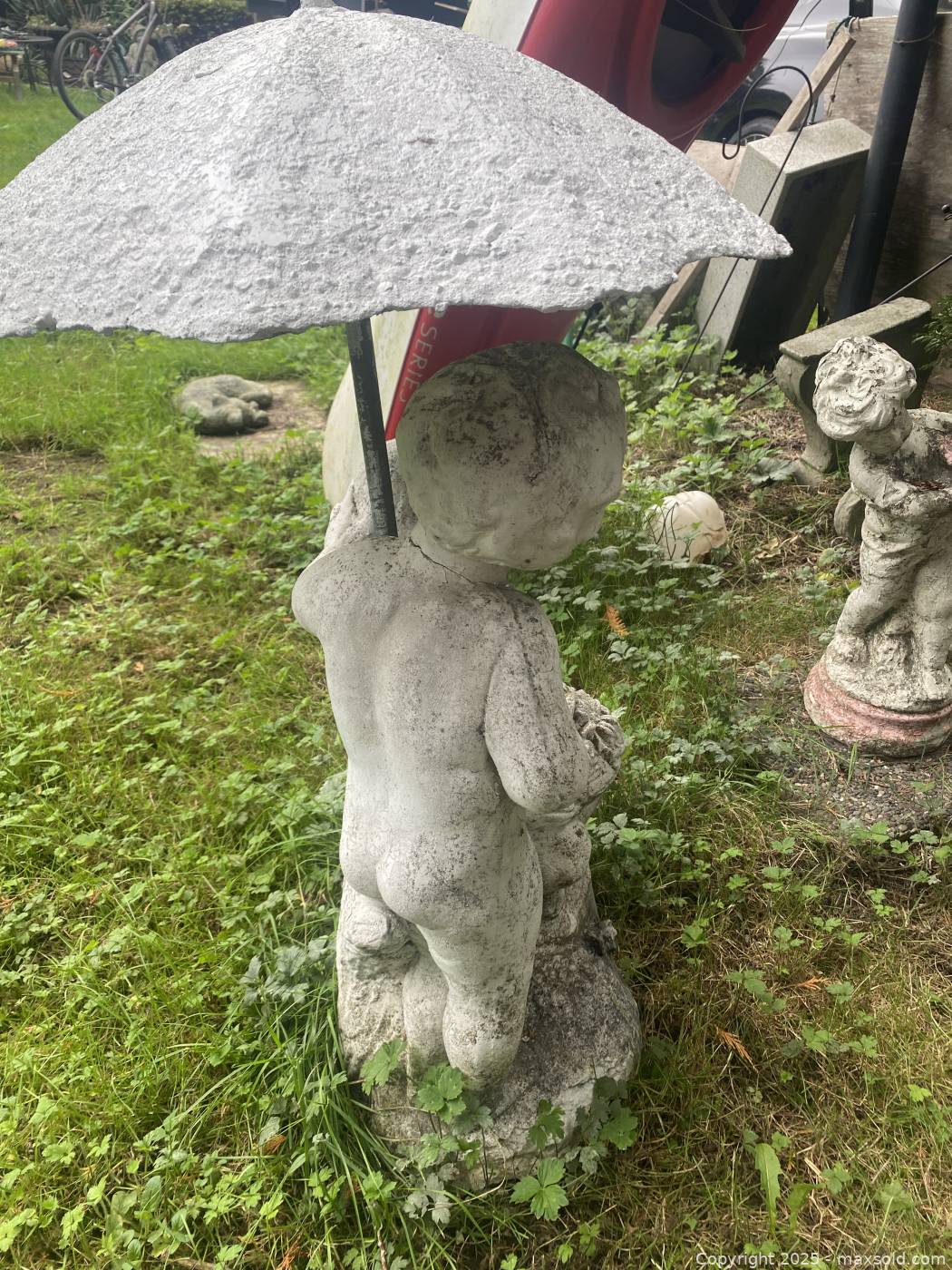 Concrete boy and girl umbrella statue 38in | Maxsold