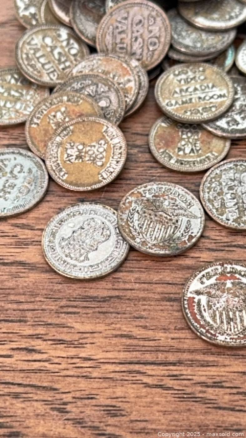 Bag of assorted vintage arcade tokens | Maxsold