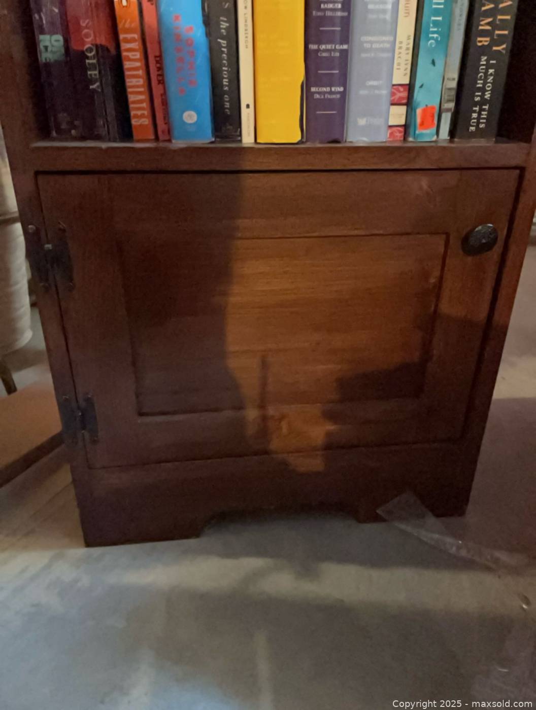 Wooden bookcase with assorted books and DVDs | Maxsold