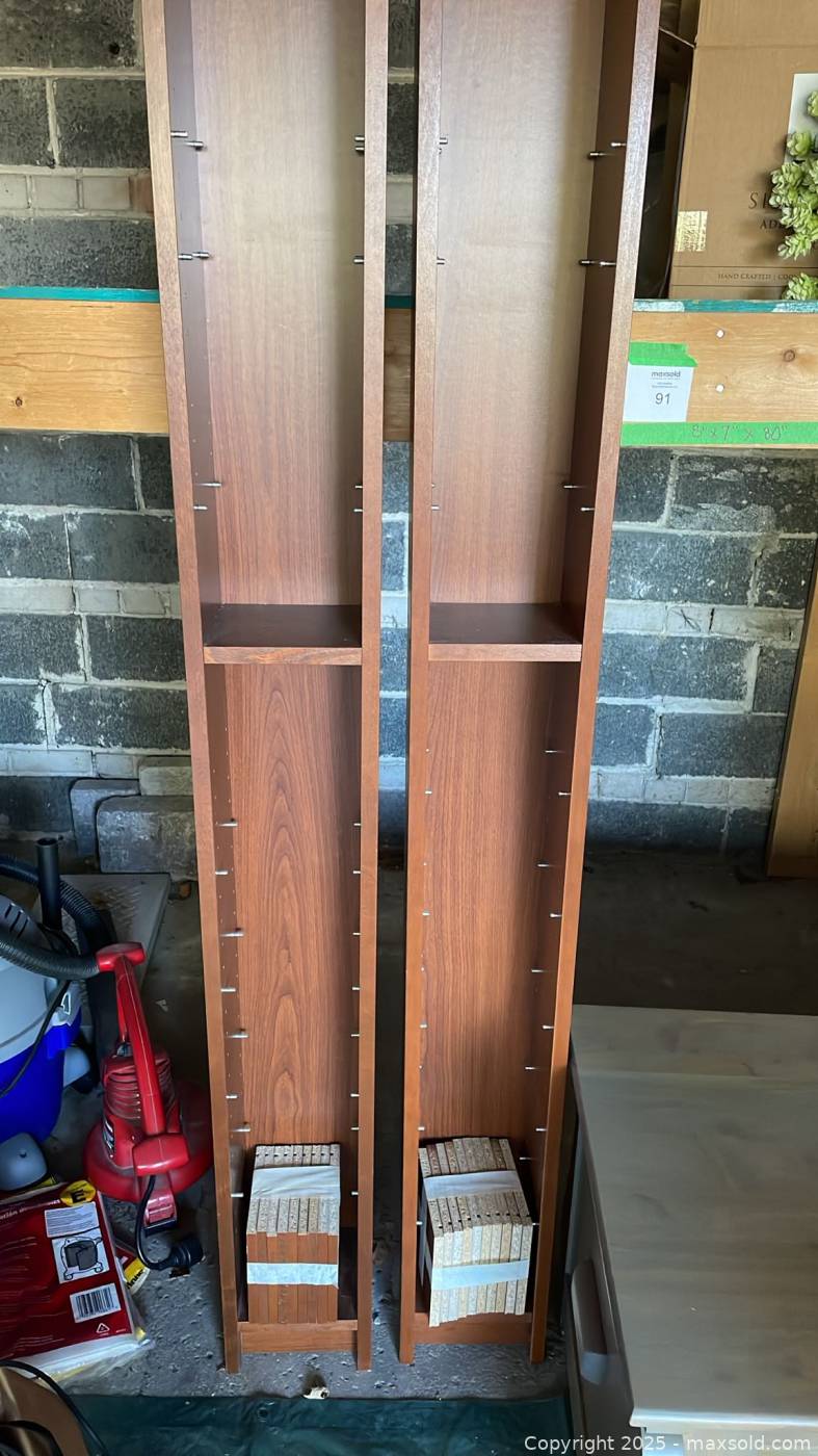 Pair of tall narrow media storage towers | Maxsold