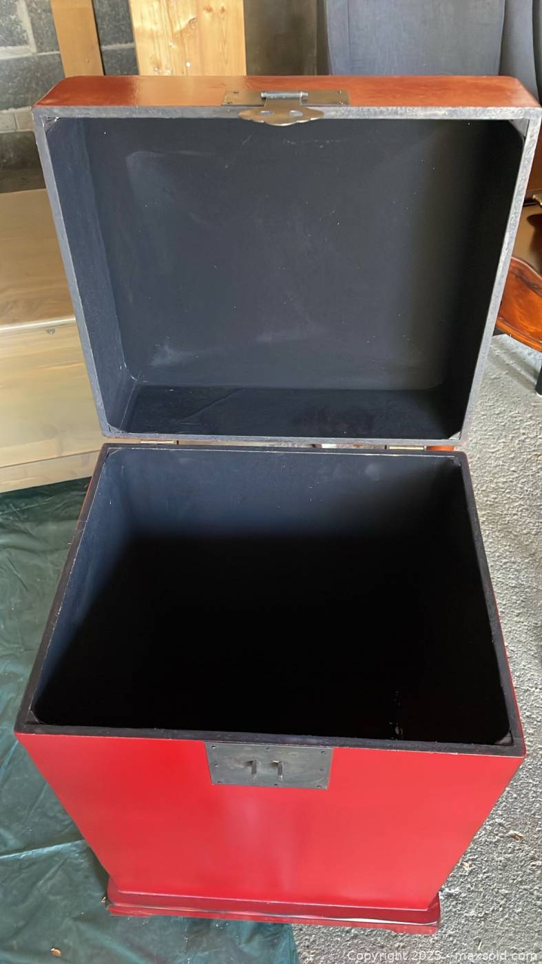 Tall red lacquer-style wood storage trunk | Maxsold