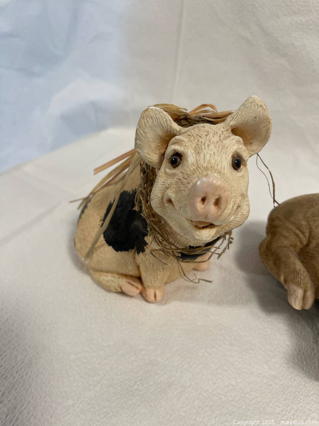 Three pig figurines with black patches | Maxsold