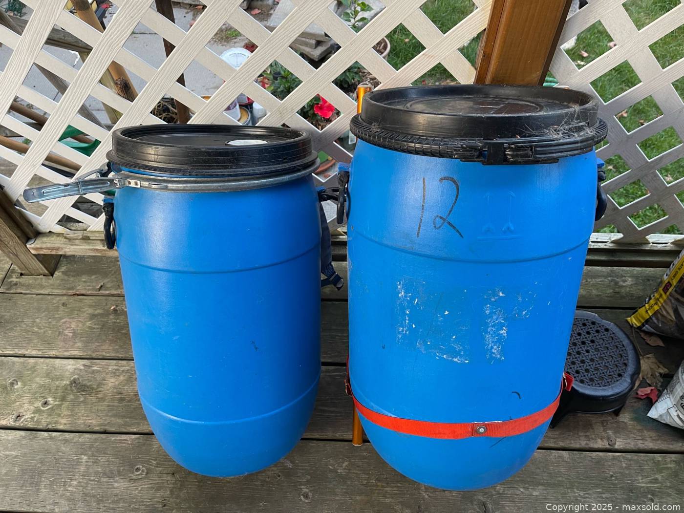 Two blue food storage barrels with frames | Maxsold