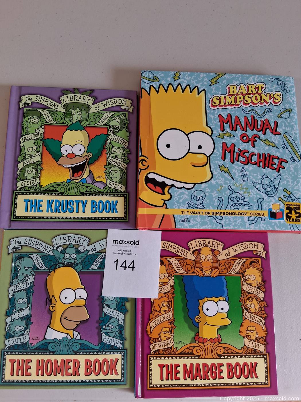 The Simpsons hardcover character books | Maxsold