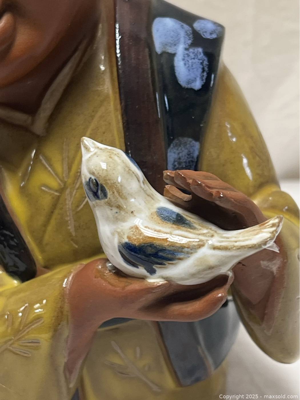 9" hand-painted ceramic child figurine holding bird | Maxsold