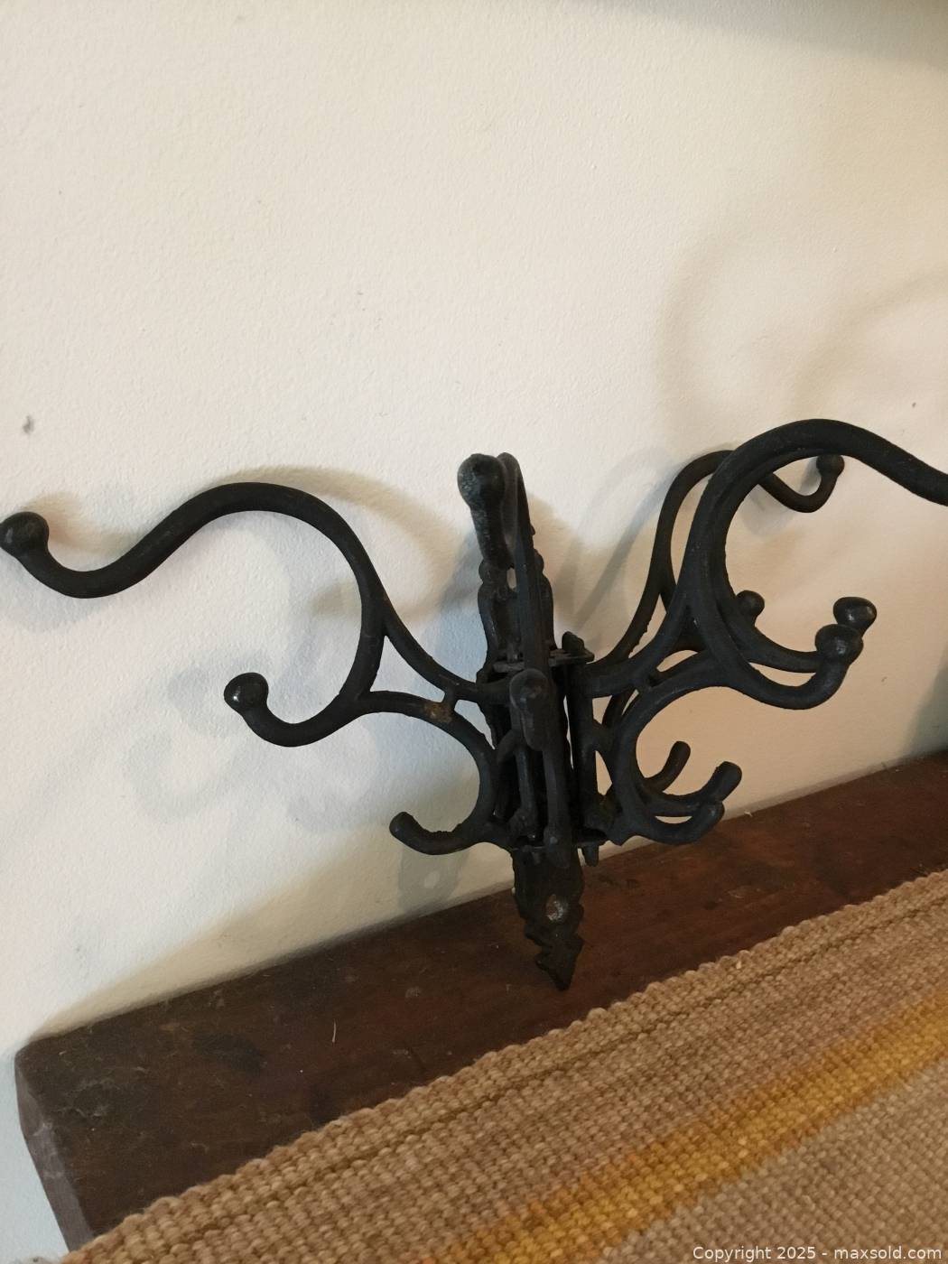 Vintage black cast iron collapsible wall hanger | Maxsold