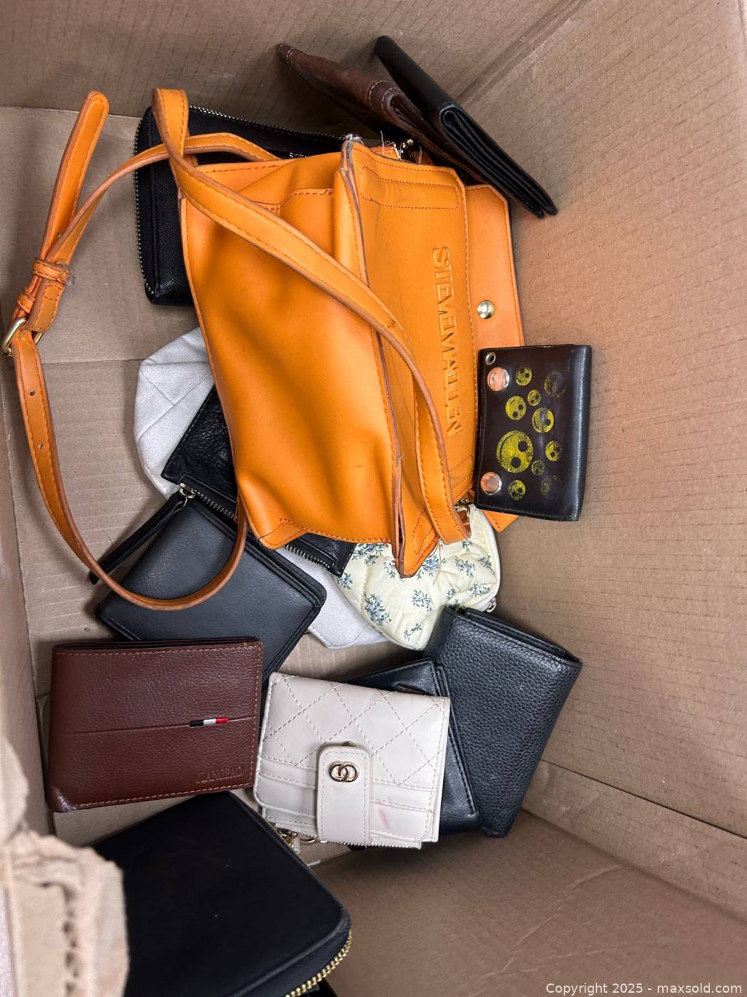 Box of assorted wallets and three new hats | Maxsold