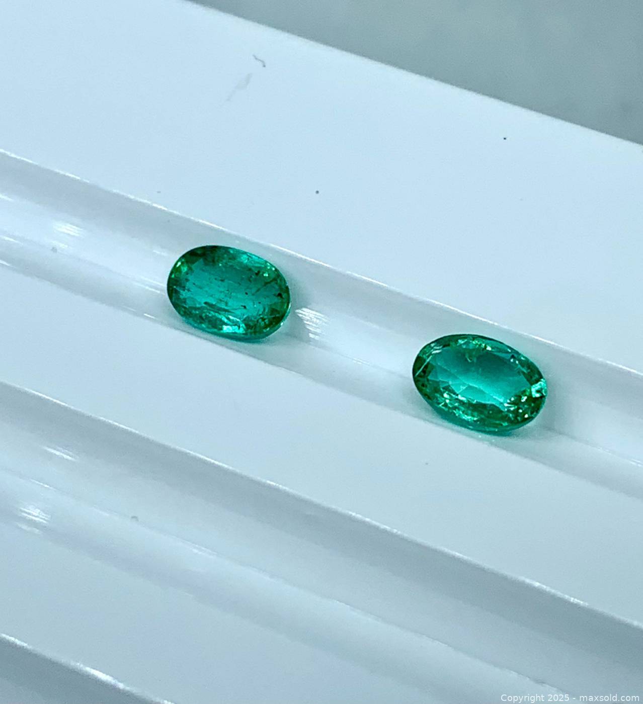 Two AAA oval Colombian emerald gemstones | Maxsold