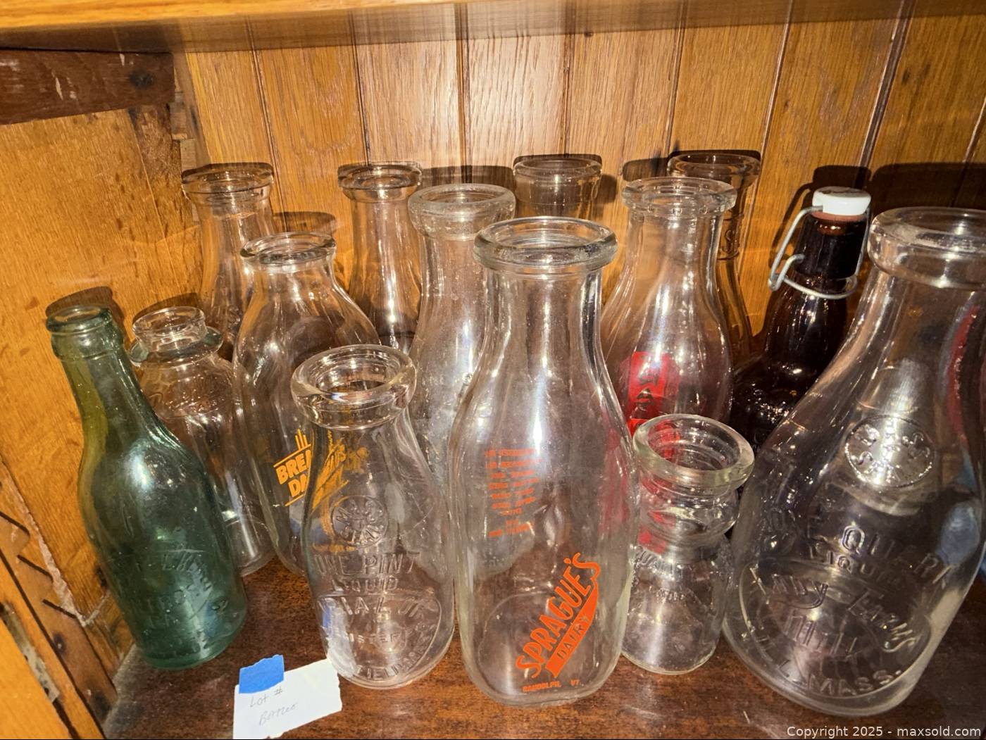 Assorted vintage glass milk, soda and beer bottles | Maxsold