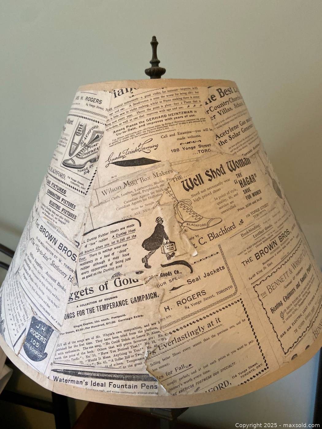Metal table lamp with newspaper print shade | Maxsold