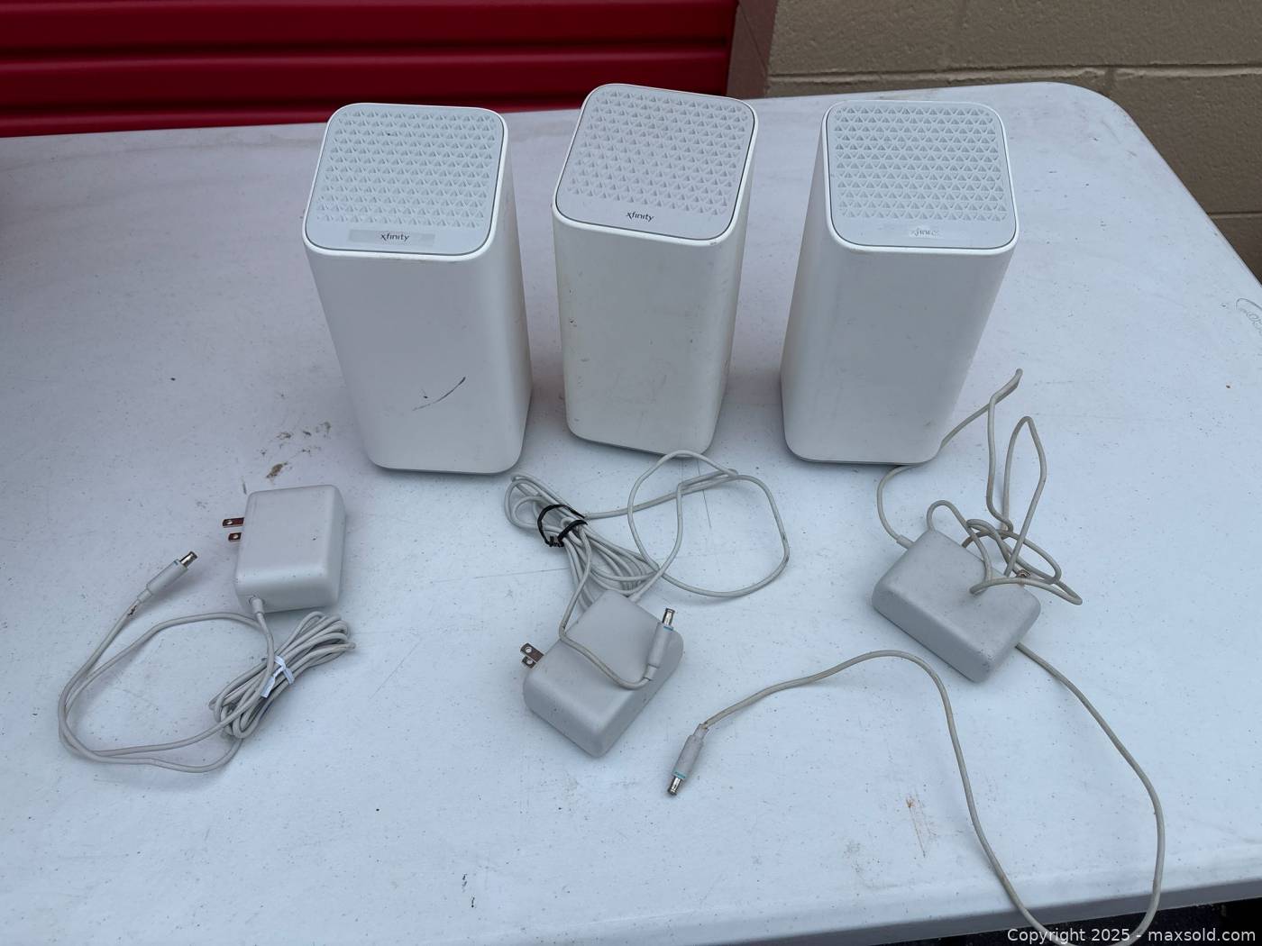 Three Xfinity WiFi gateway modem-routers with power adapters | Maxsold