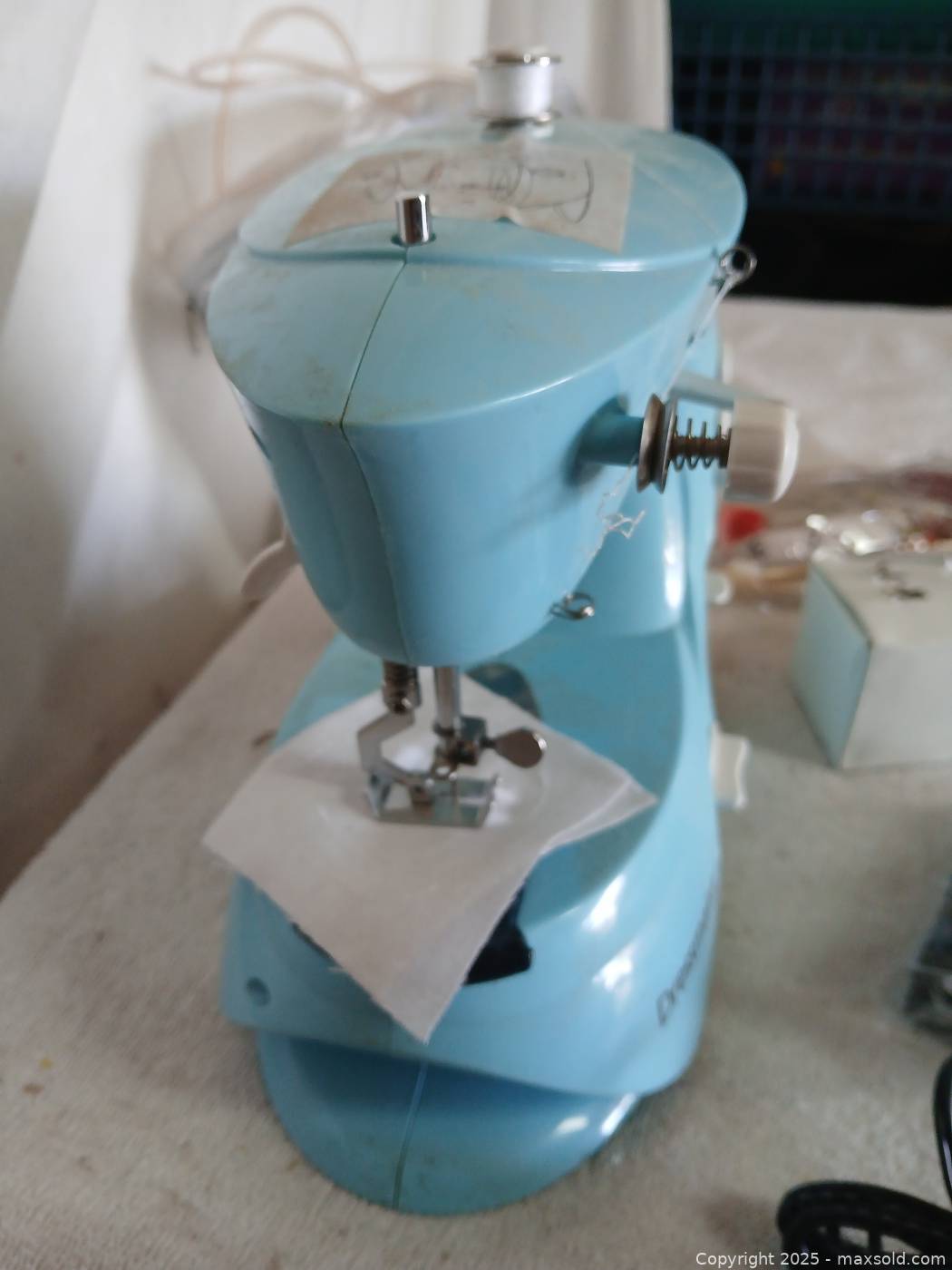 Dressmaker portable sewing machine with accessories | Maxsold