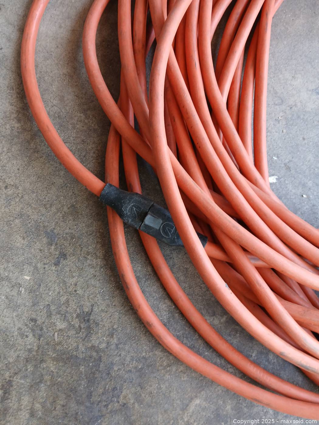 Large orange extension cord | Maxsold