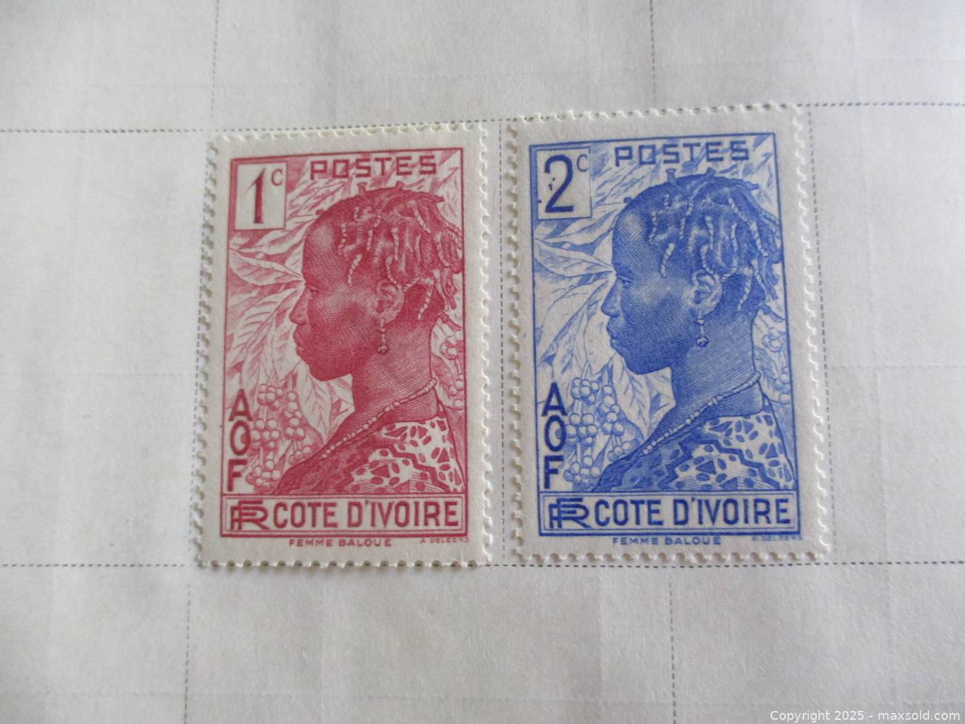 Ivory Coast Scott album page with 1c and 2c stamps | Maxsold