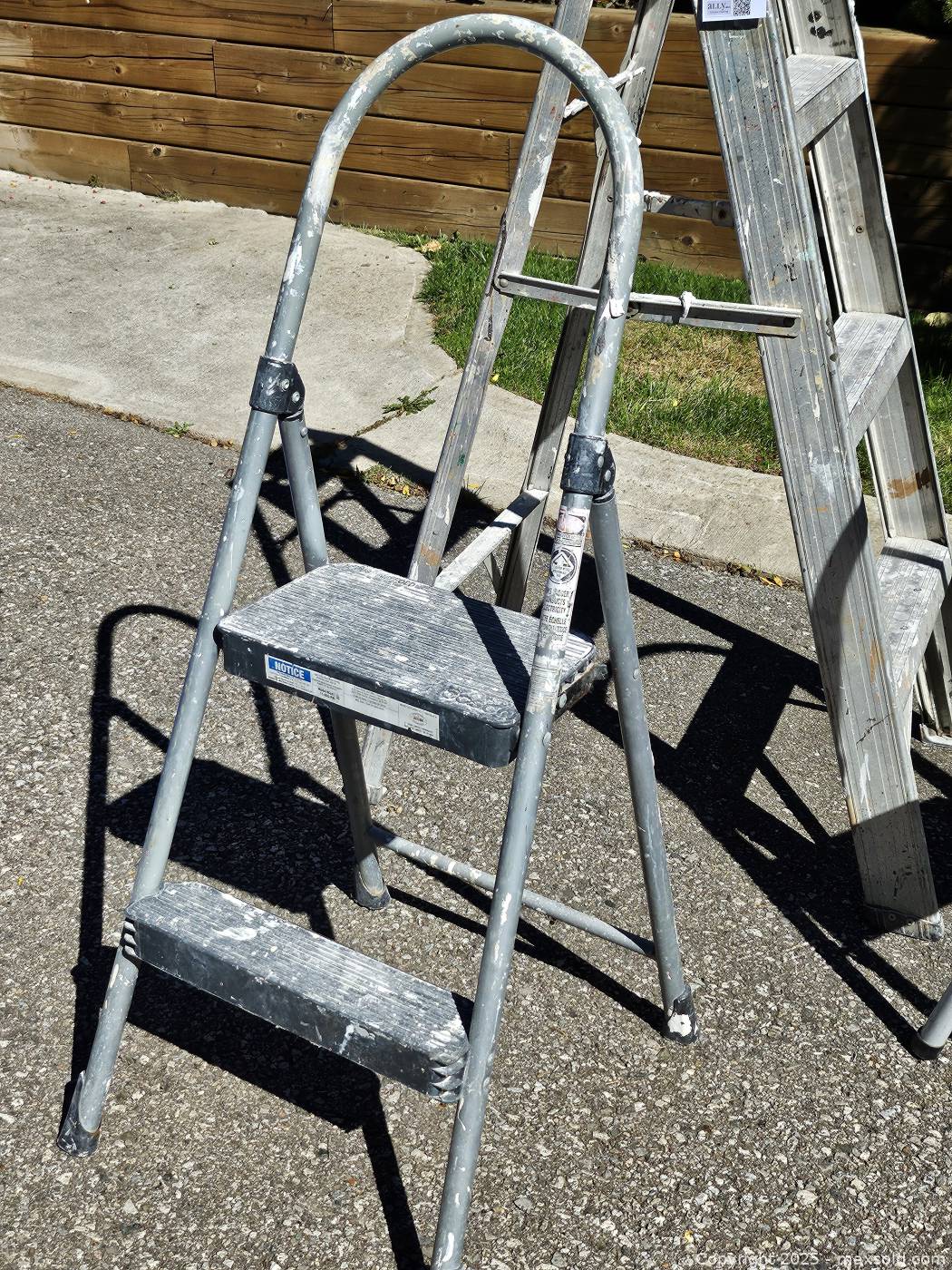 Three metal step ladders | Maxsold