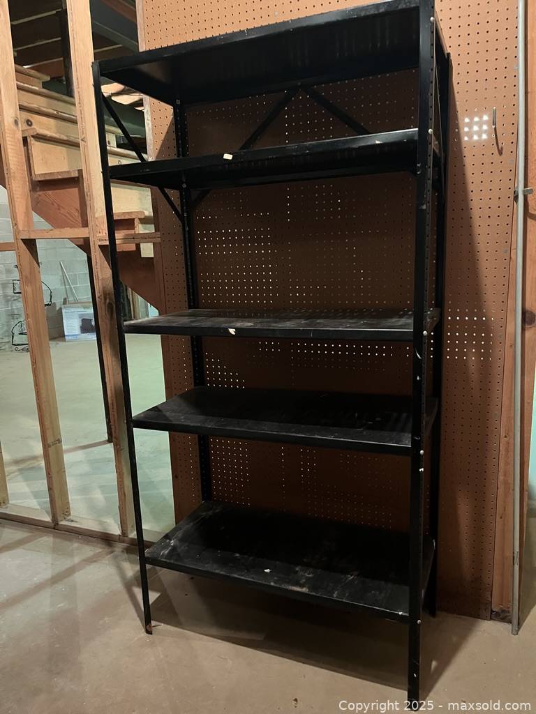 Metal shelving units and wrought iron plant stand | Maxsold