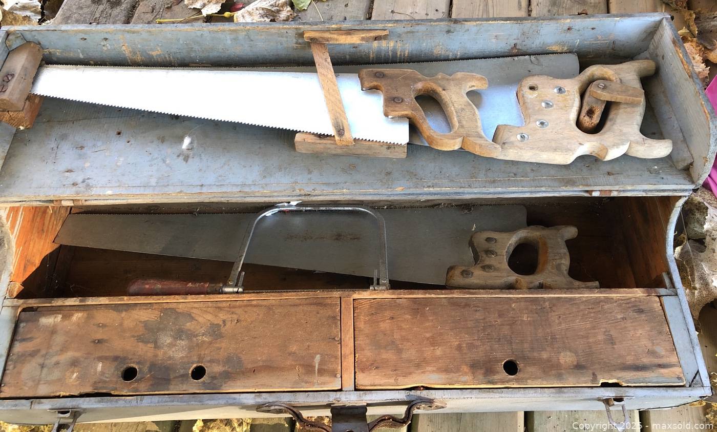 Wooden toolbox with hand saws | Maxsold