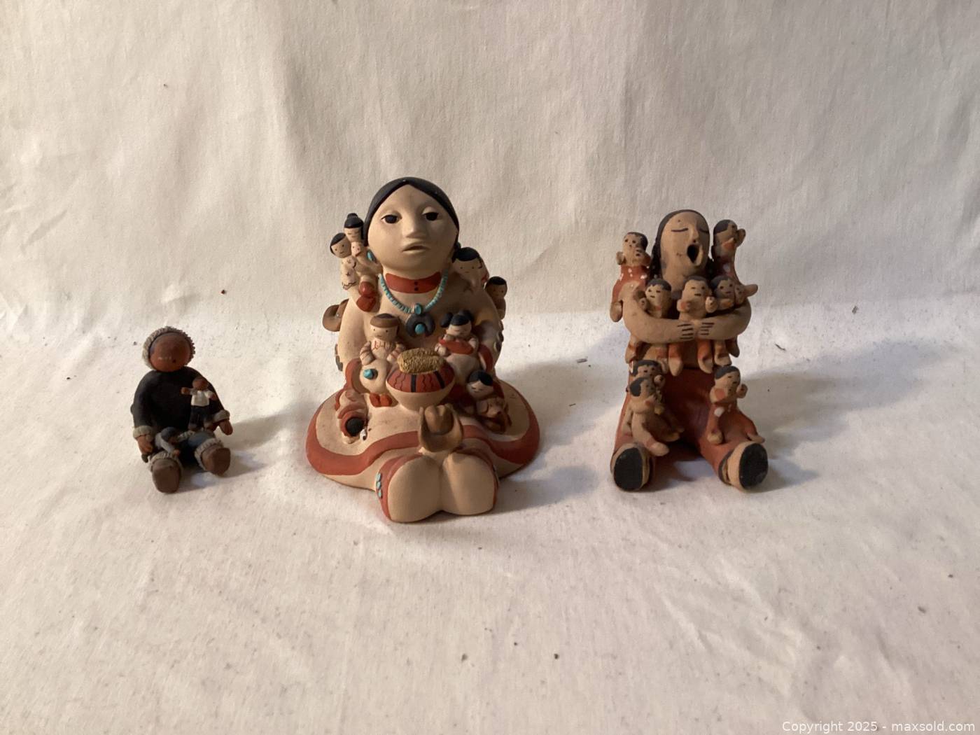 Three ceramic storyteller doll figurines | Maxsold