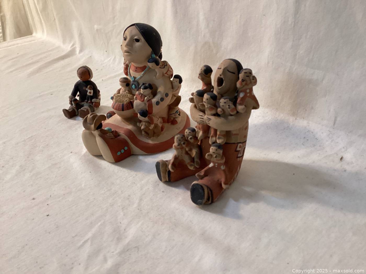 Three ceramic storyteller doll figurines | Maxsold