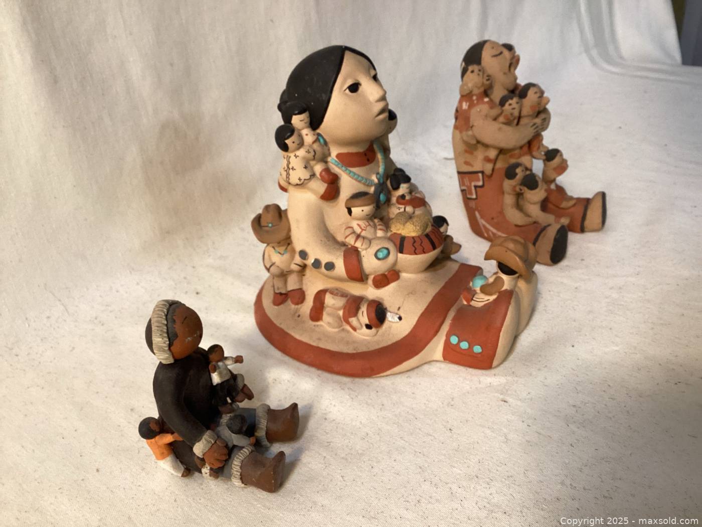 Three ceramic storyteller doll figurines | Maxsold