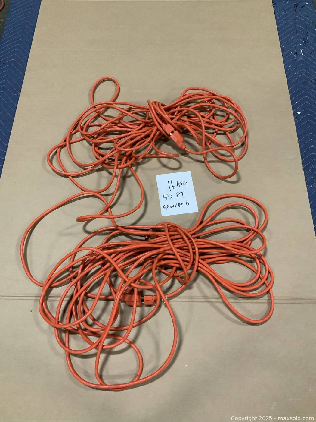 Two 50-ft orange extension cords | Maxsold