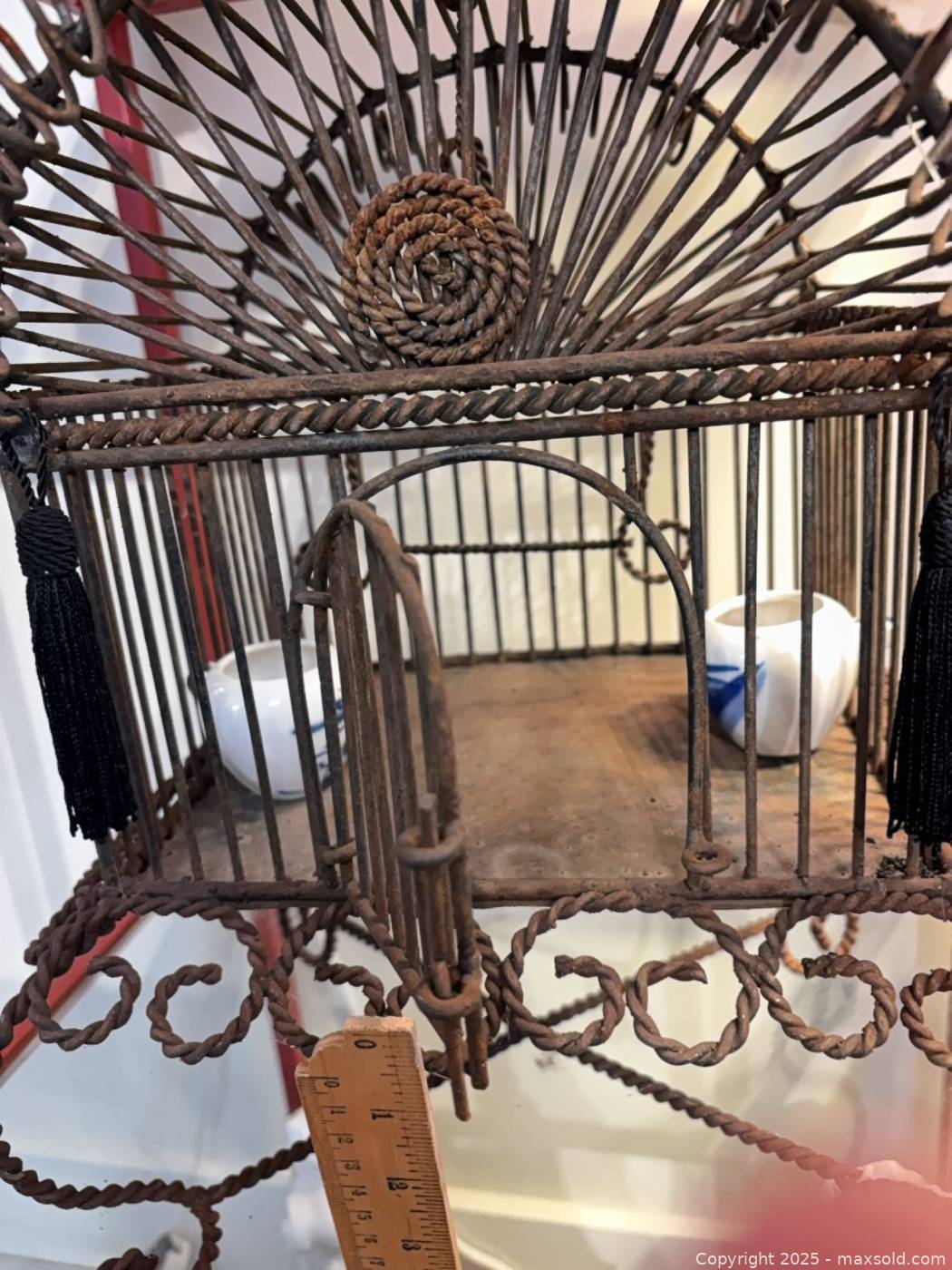 Vintage wire bird cage, bronze bookends, potted plants | Maxsold