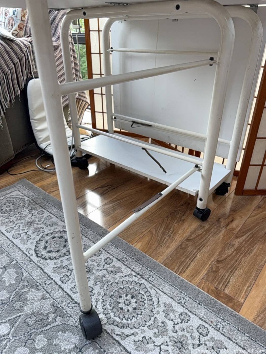 White folding work table on casters with clamp lamp | Maxsold