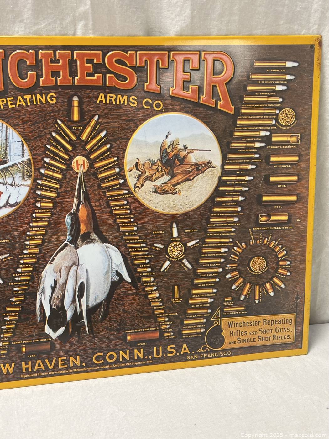 Embossed Winchester Repeating Arms metal sign | Maxsold