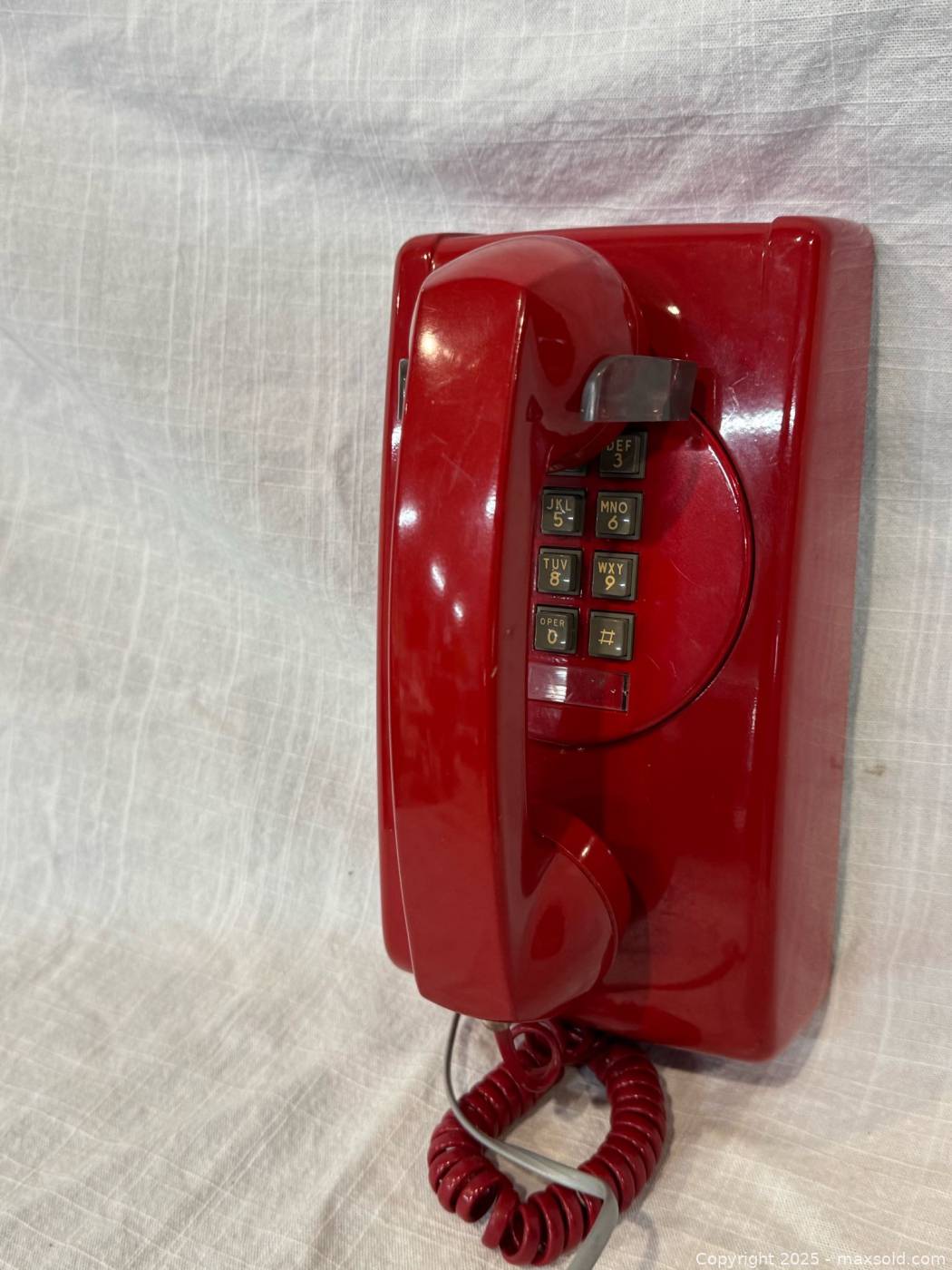 Vintage red wall-mounted push-button telephone | Maxsold