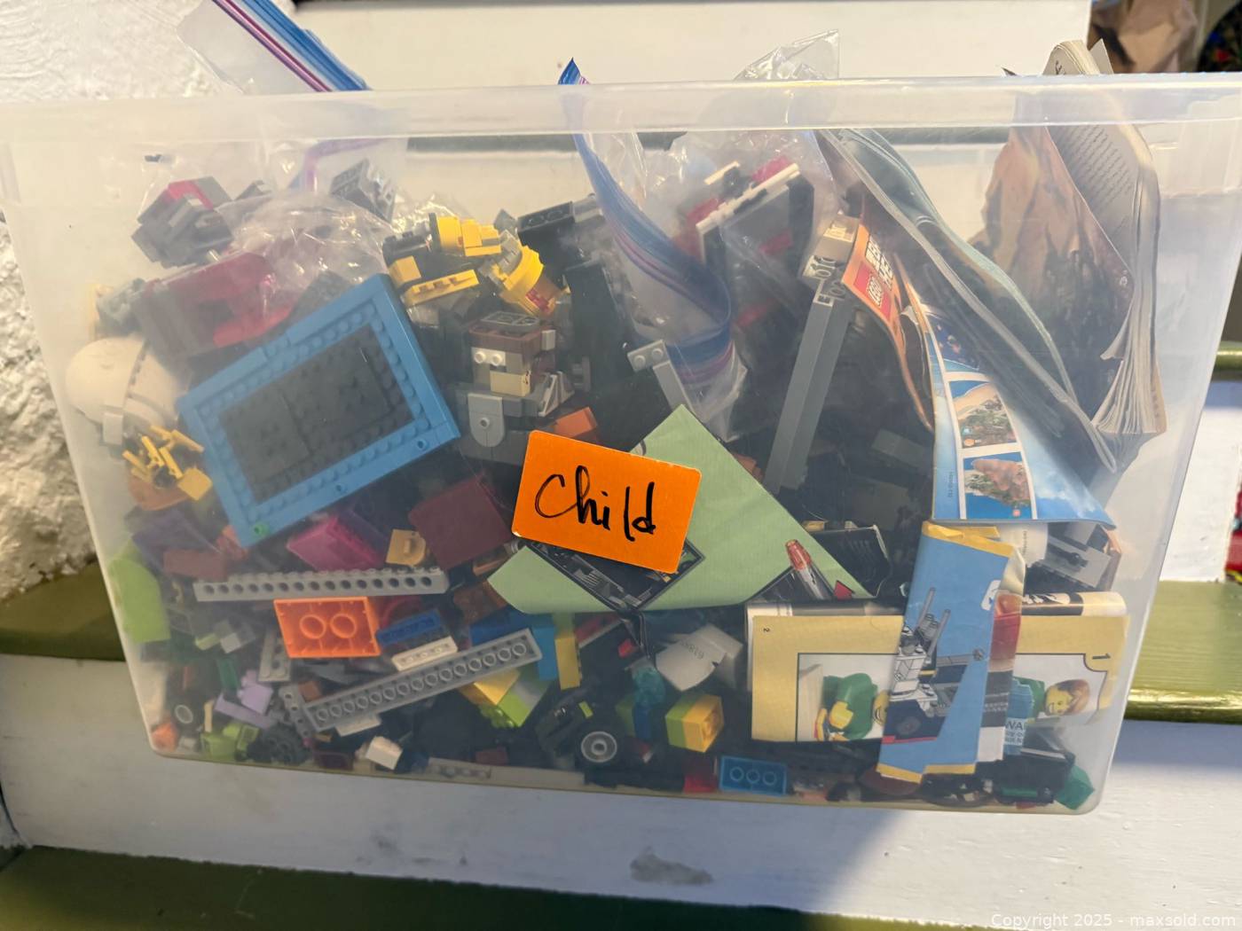 Clear tote of mixed LEGO bricks, manuals | Maxsold