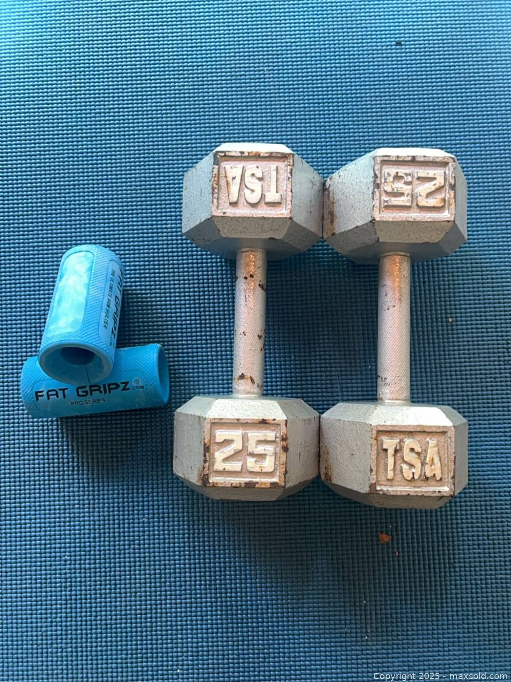 Pair of 25 lb hex dumbbells and Fat Gripz Pro Series grips | Maxsold