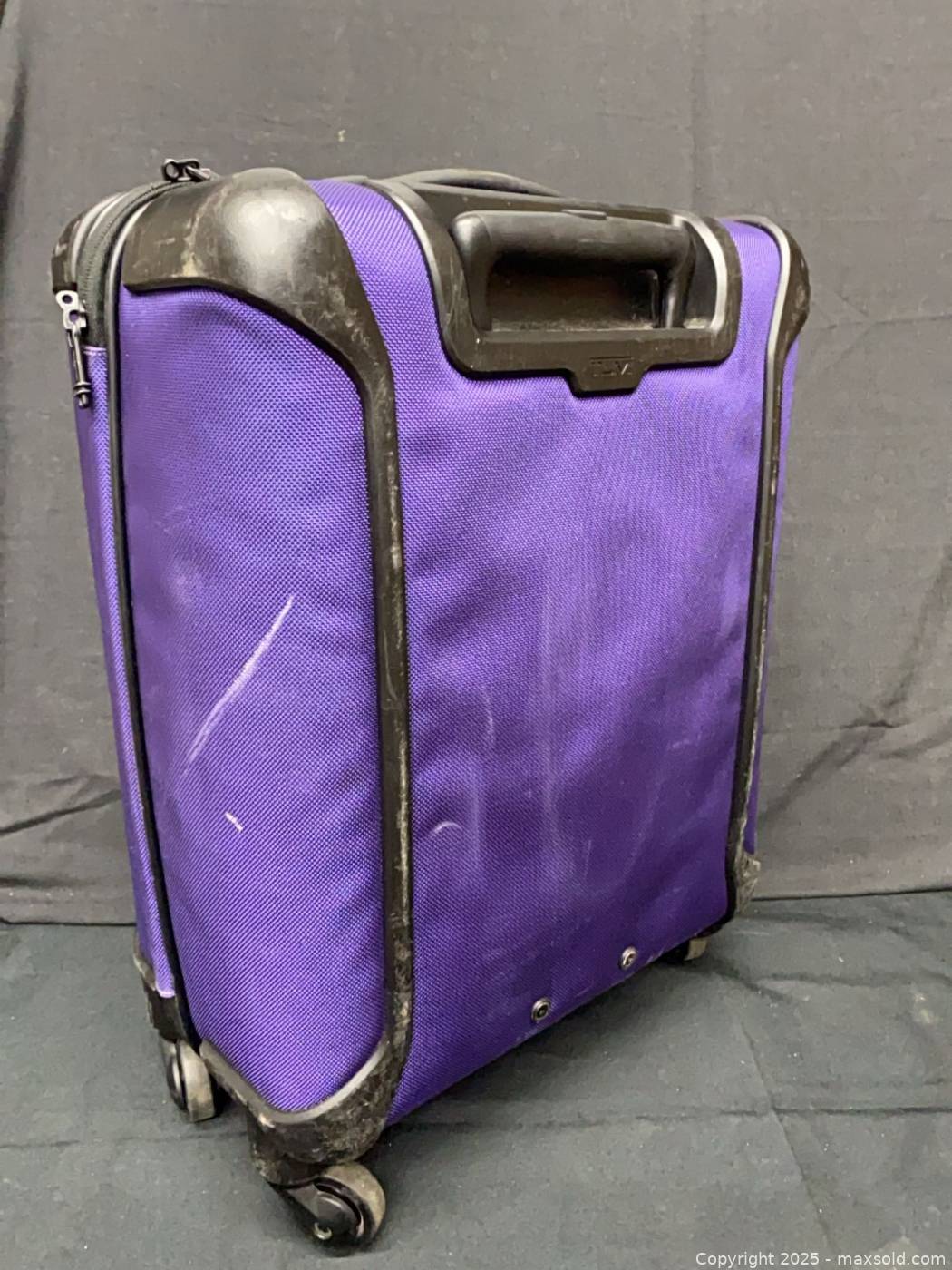 Purple Tumi wheeled carry-on luggage | Maxsold