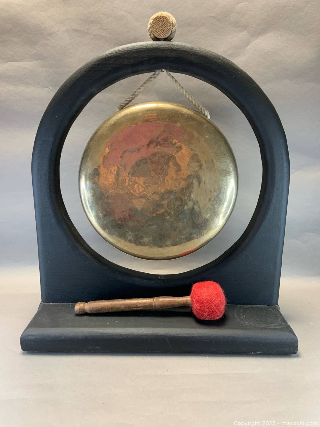 Small brass gong on black wood stand with mallet | Maxsold