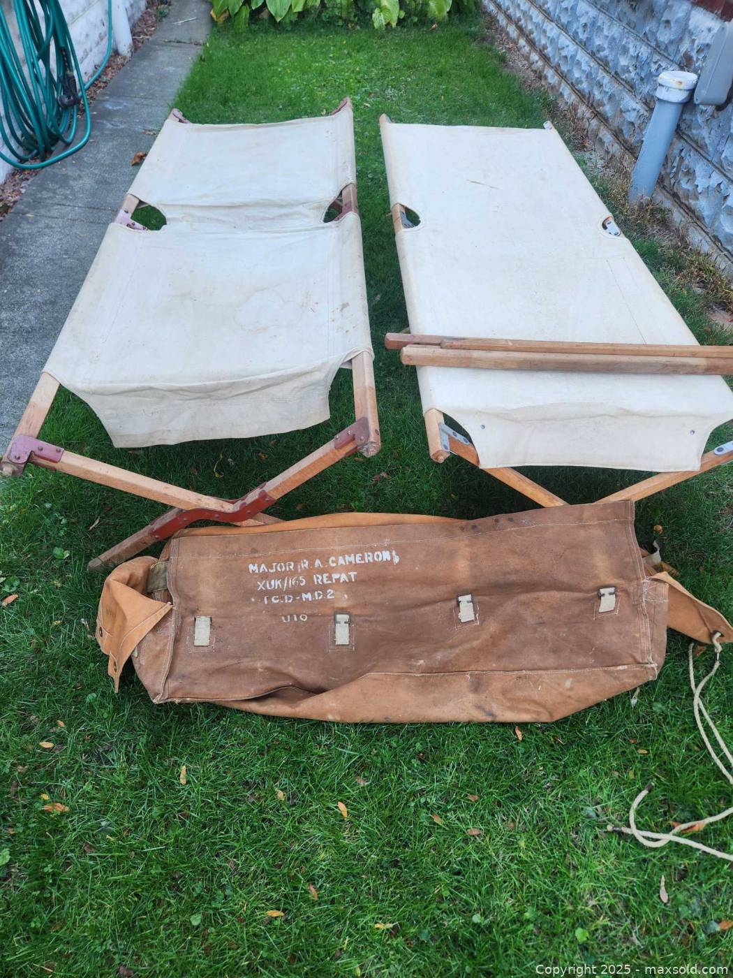 Two wooden military folding cots with canvas bag | Maxsold