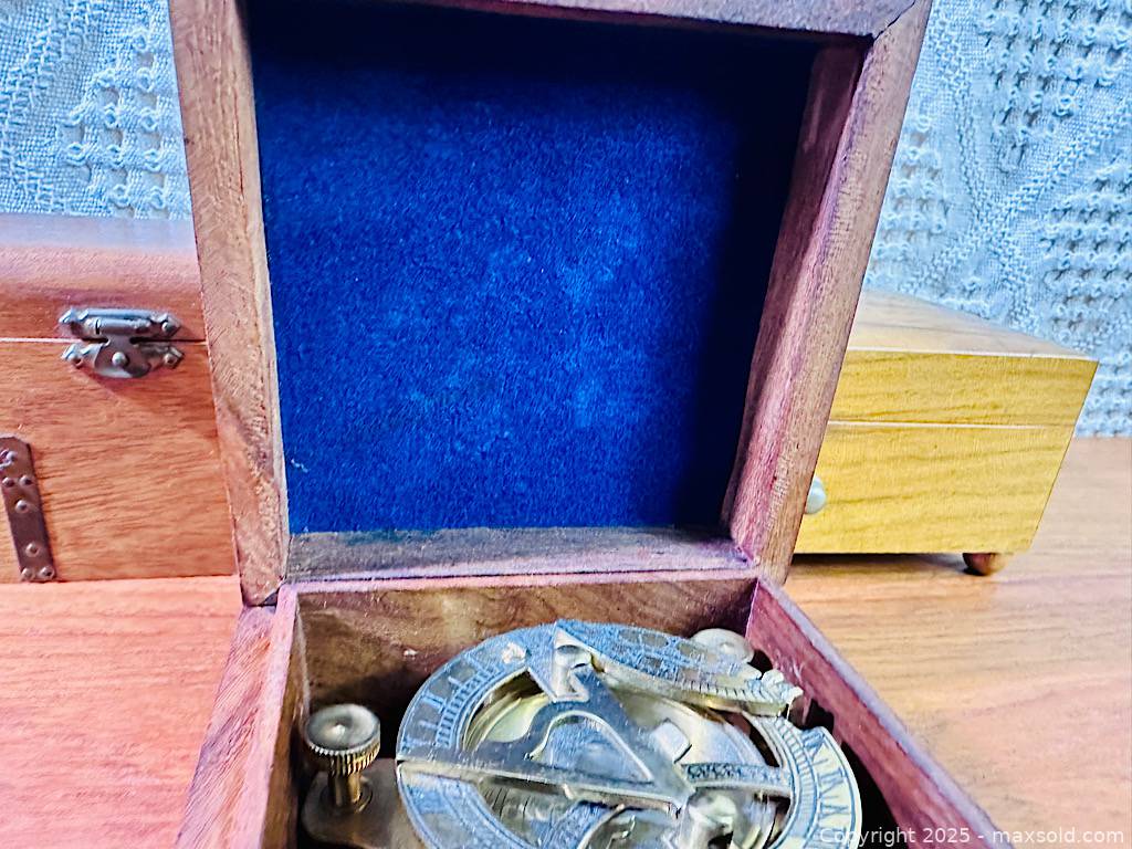 Brass sundial compass with box and two Swiss wooden music boxes | Maxsold
